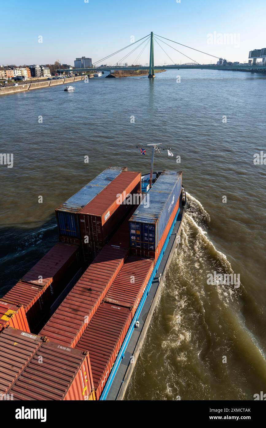 Container cargo ship on the Rhine, heading south, the crane houses in ...