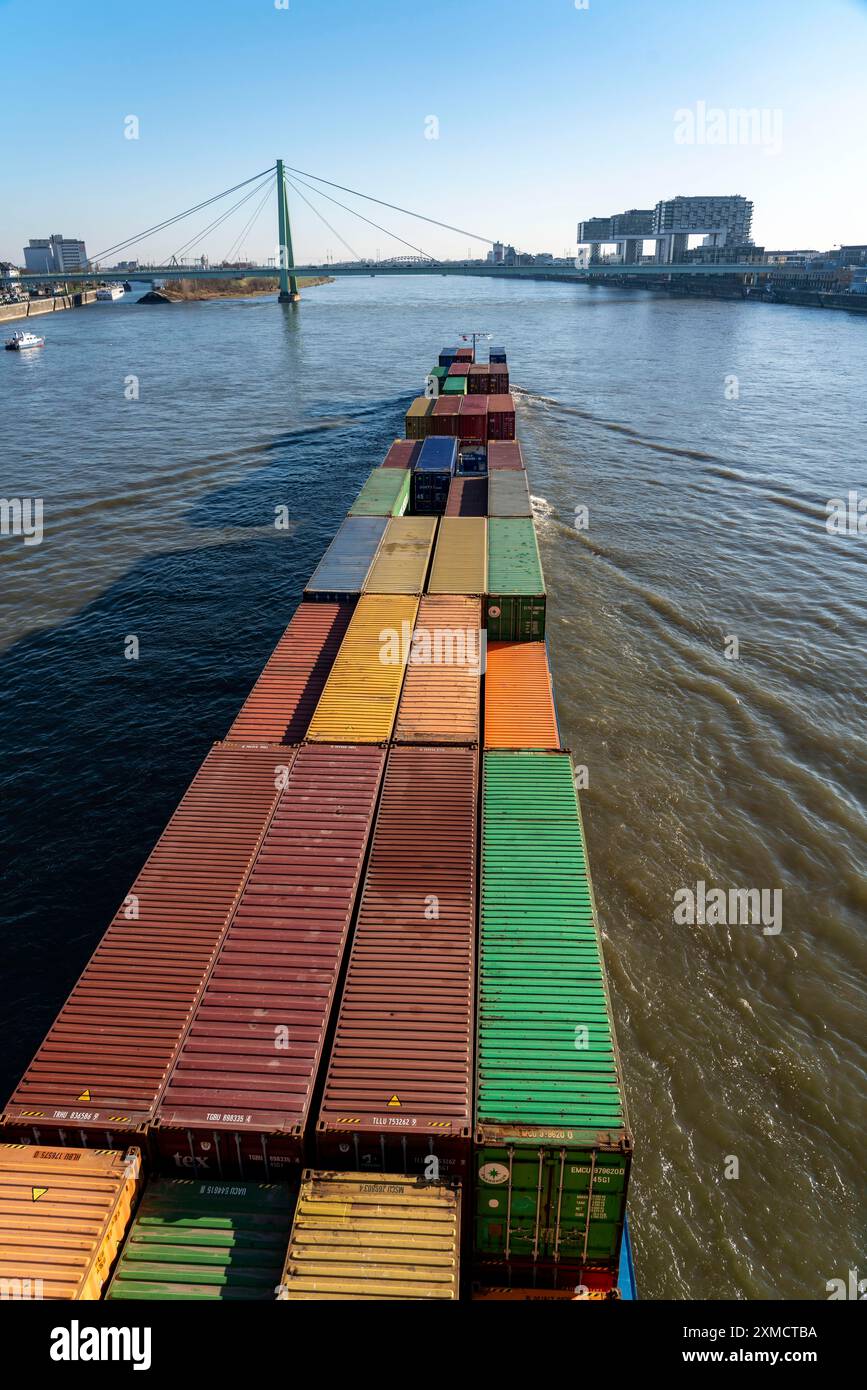 Container cargo ship on the Rhine, heading south, the crane houses in ...