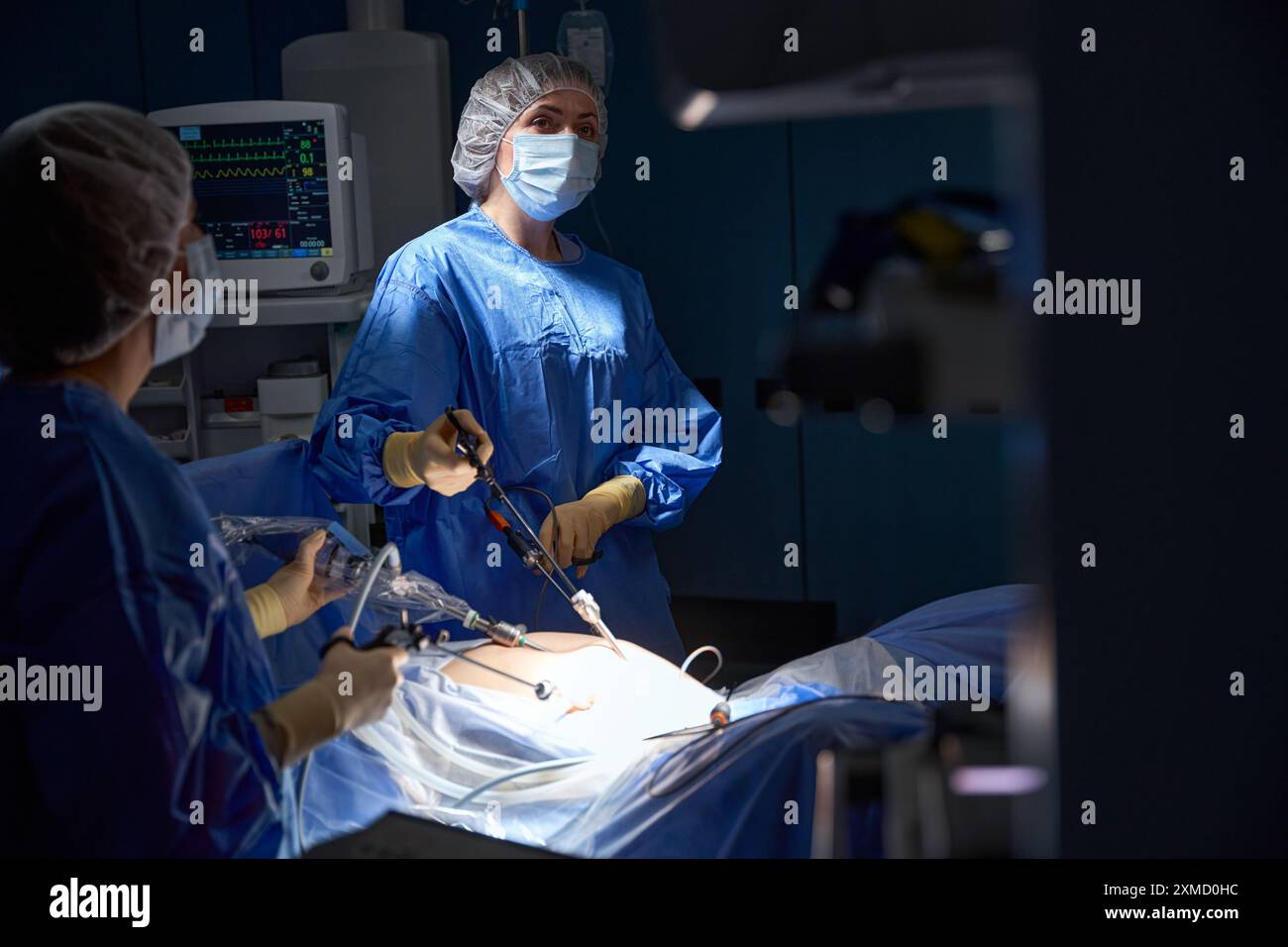 Female doctors performing laparoscopy operations in the intensive care ...