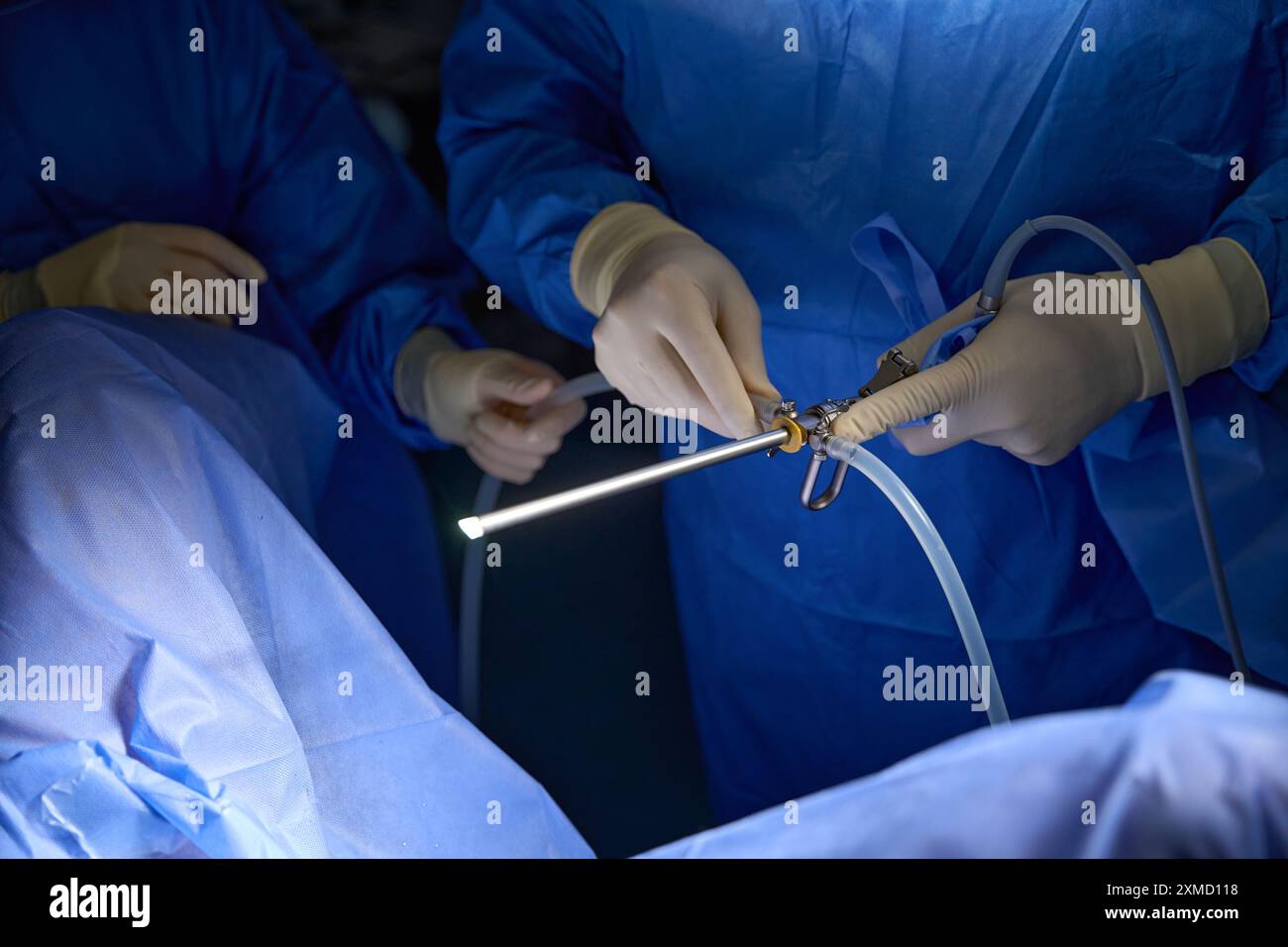 Close up of medical team performing surgery in operating room, using ...