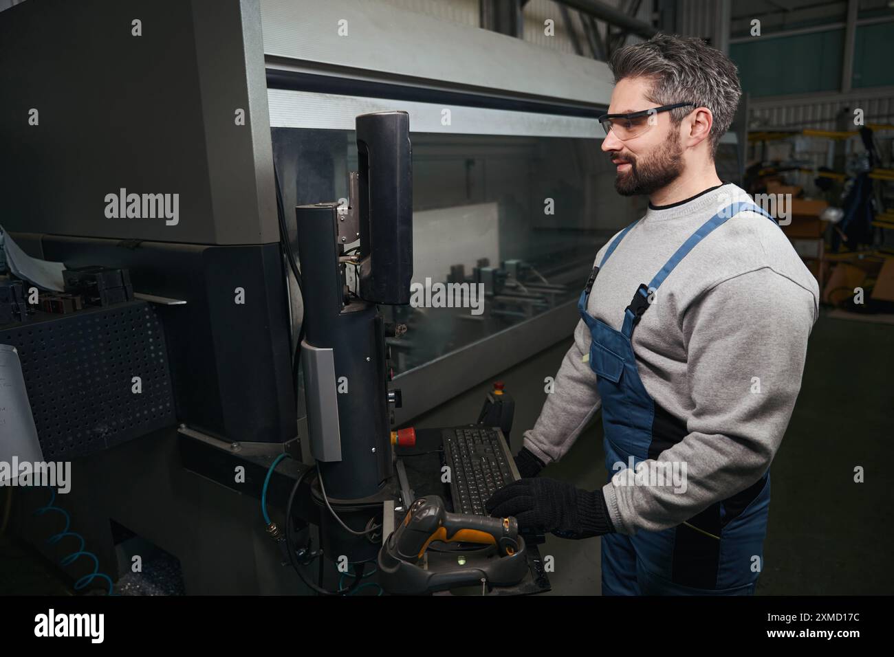 Professional uses modern equipment in production Stock Photo - Alamy