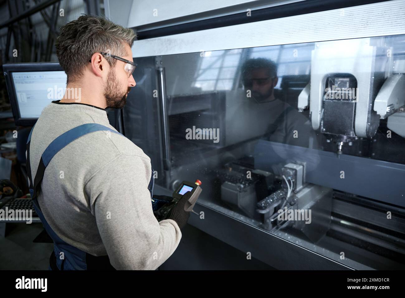 Employee uses a control panel to work on modern equipment Stock Photo ...