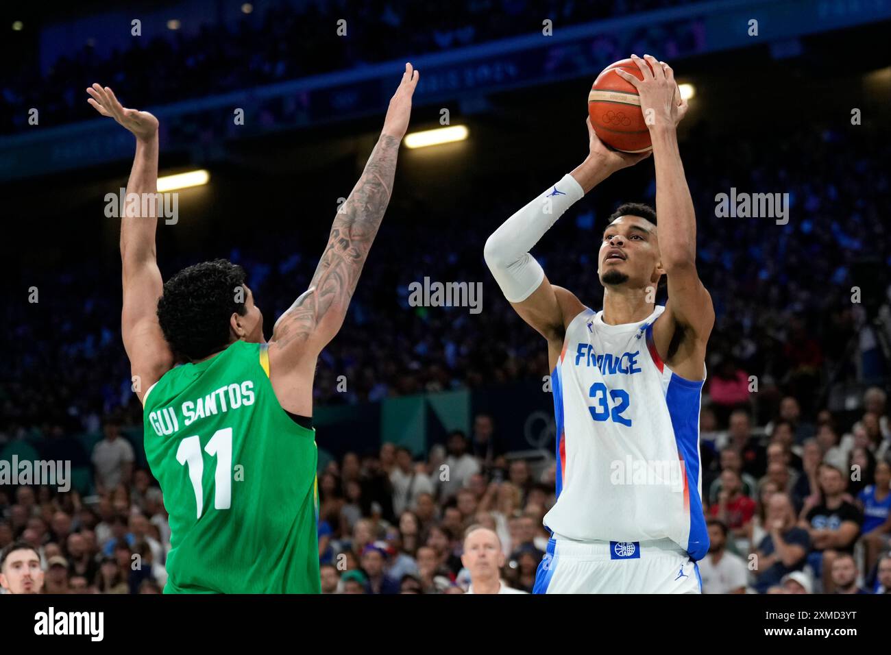 Victor Wembanyama, of France, shoots over Gui Santos, of Brazil, in a ...