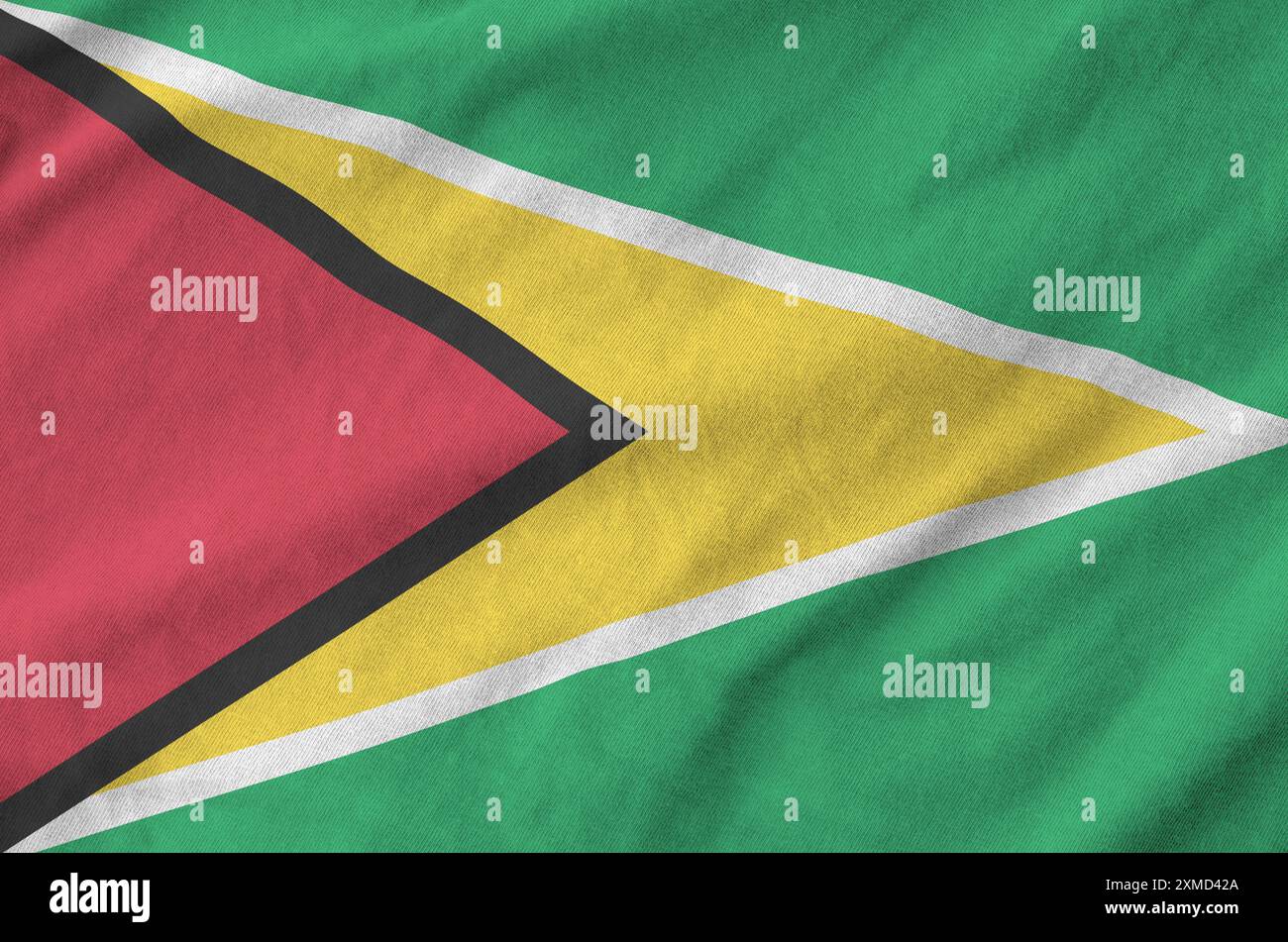 Guyana flag depicted on folded wavy fabric of old cloth close up Stock Photo - Alamy