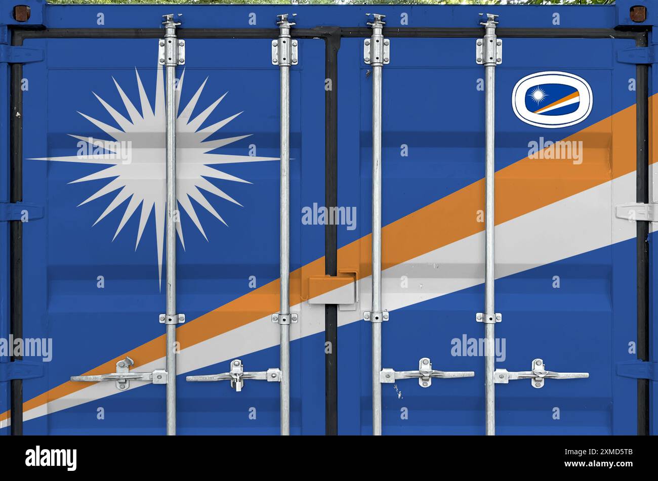 Marshall Islands flag depicted on metal doors of shipping cargo container outdoors in docks area ...