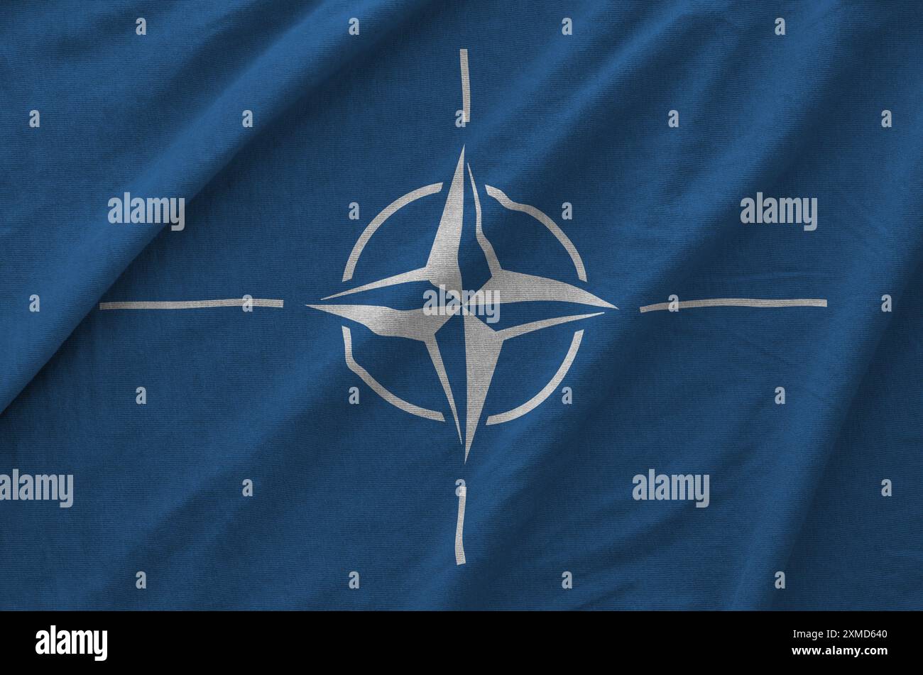 Nato flag depicted on folded wavy fabric of old cloth close up Stock ...