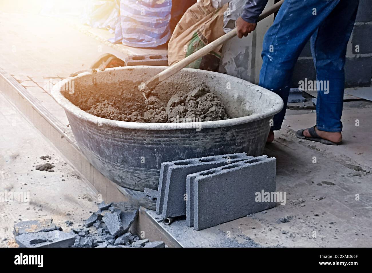 House builder mixing cement, construction Stock Photo - Alamy