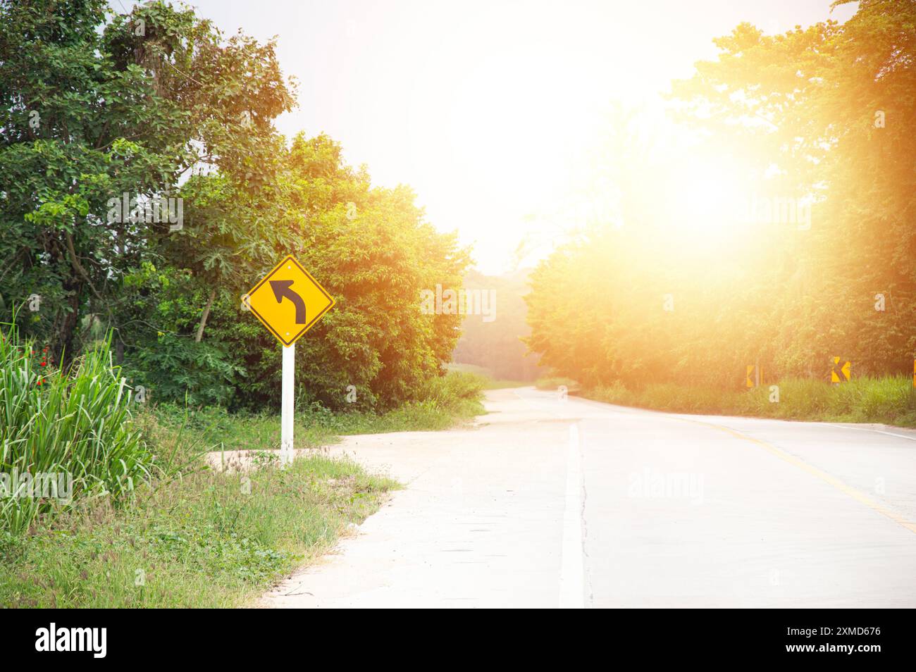 roadside signpost It shows that there is a curve ahead Stock Photo - Alamy