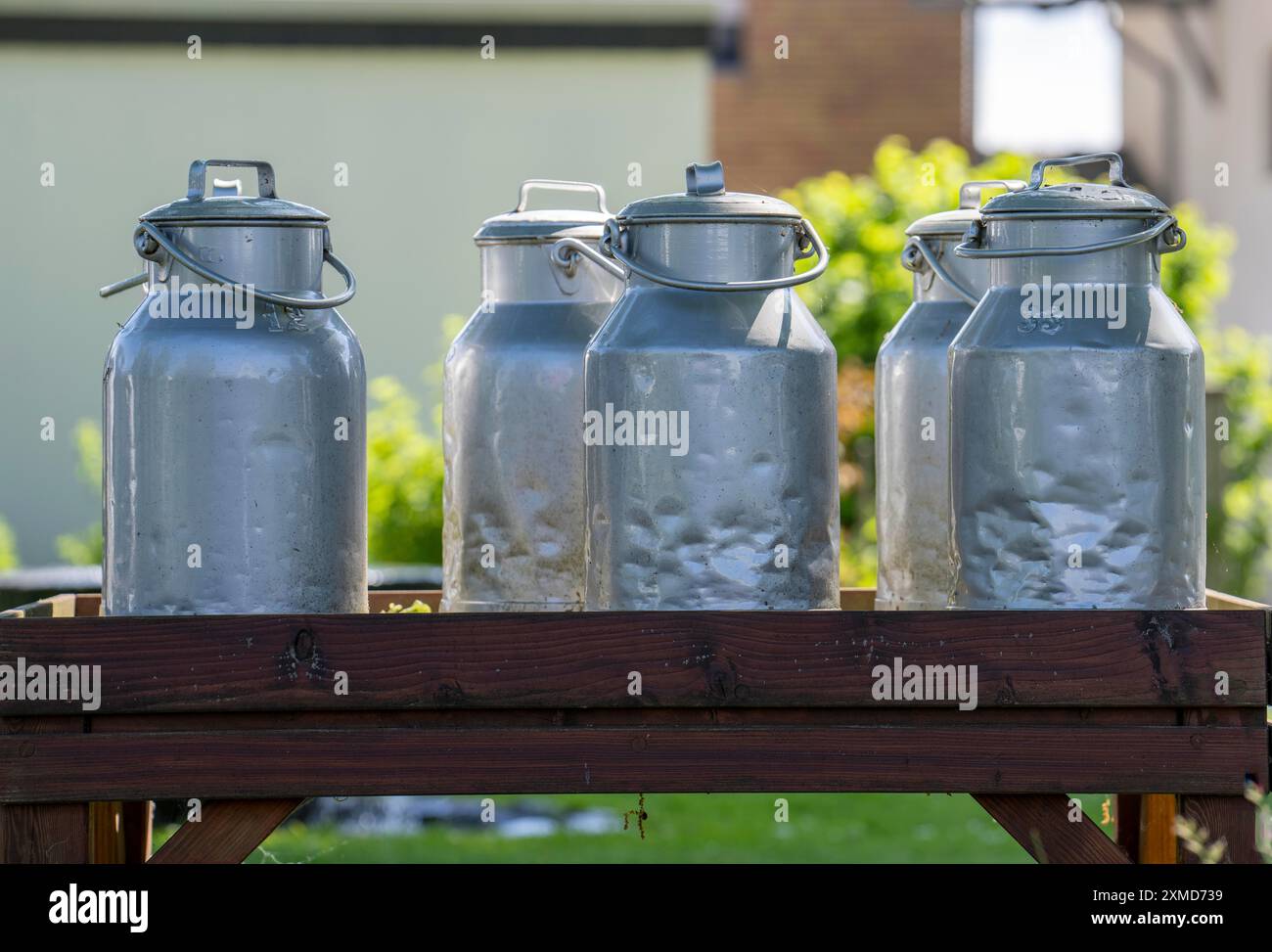 Milk stand, with old milk cans, erected as a reminder of earlier times ...