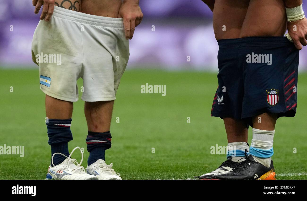 United States' Steve Tomasin, left, exchanges shorts with Argentina's ...