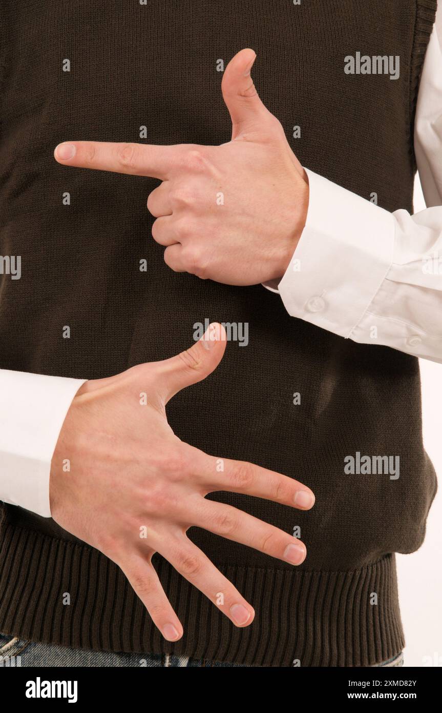 Two male hands held in front of the stomach symbolize the number 7 with ...