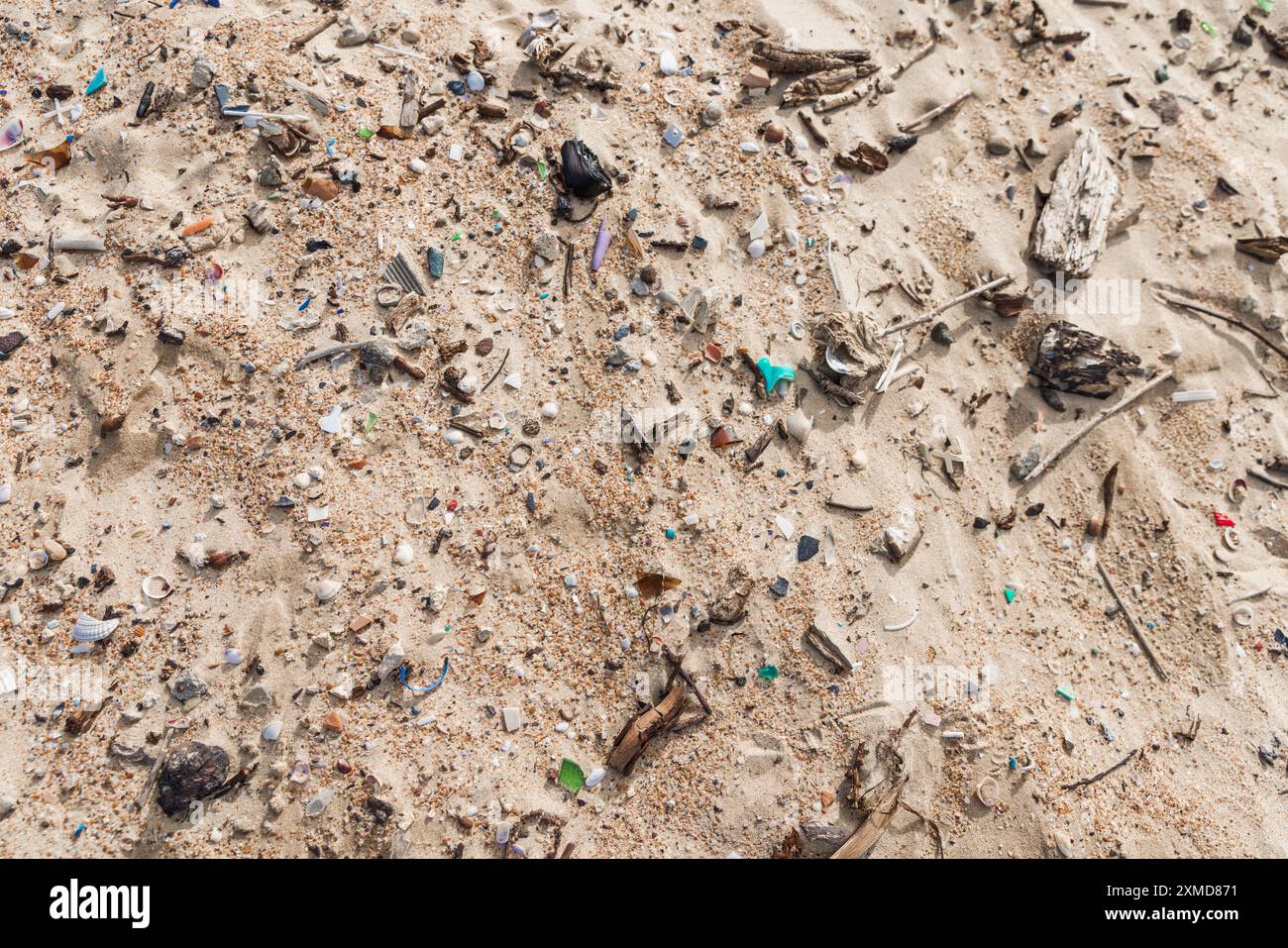 Pollution by microplastic rubbish on coastline. Plastic garbage in sand ...