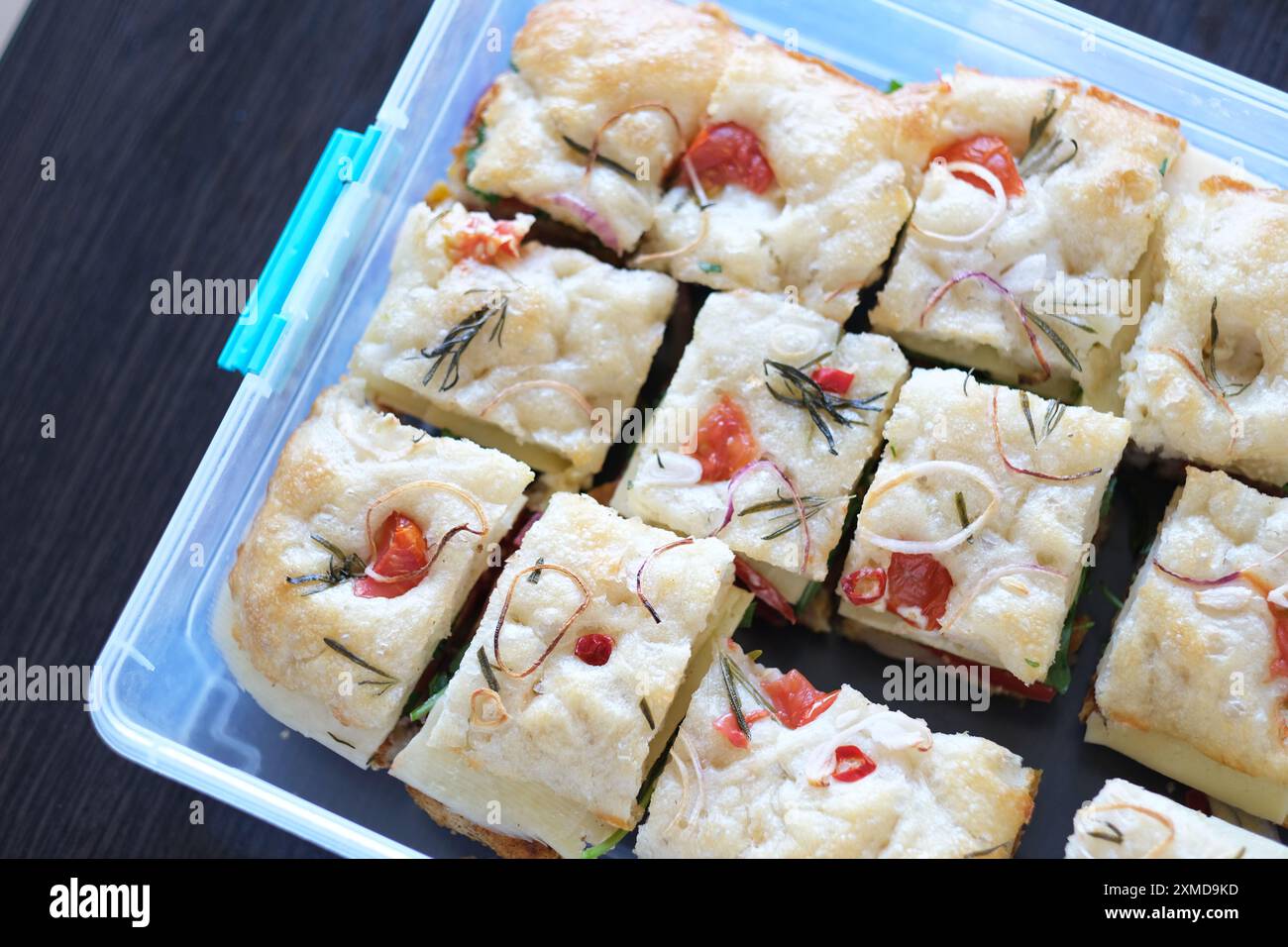 Handmade Italian bread with vegetables, cut into portions in a plastic ...