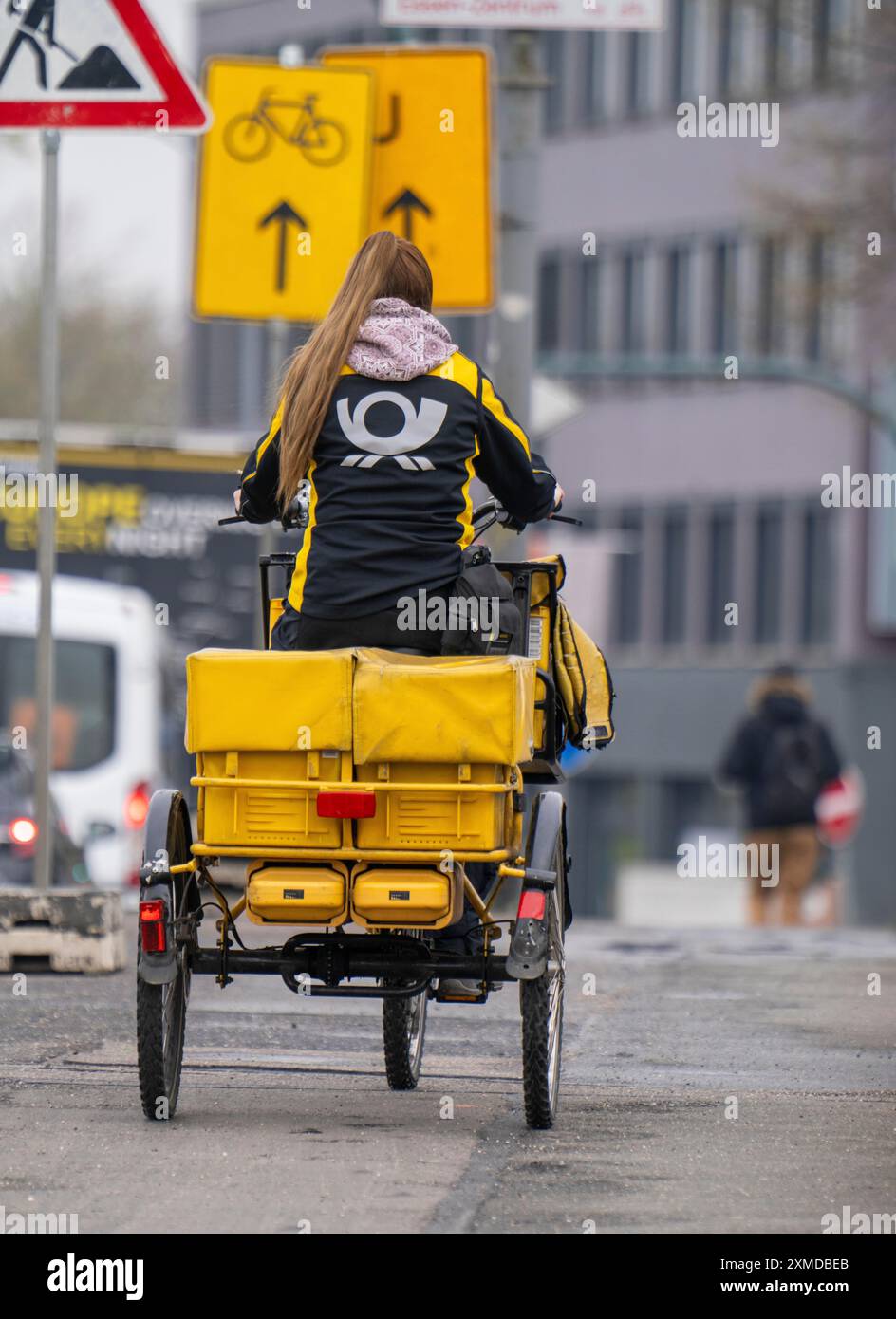 Deutsche Post delivery woman on an electric post tricycle Stock Photo ...