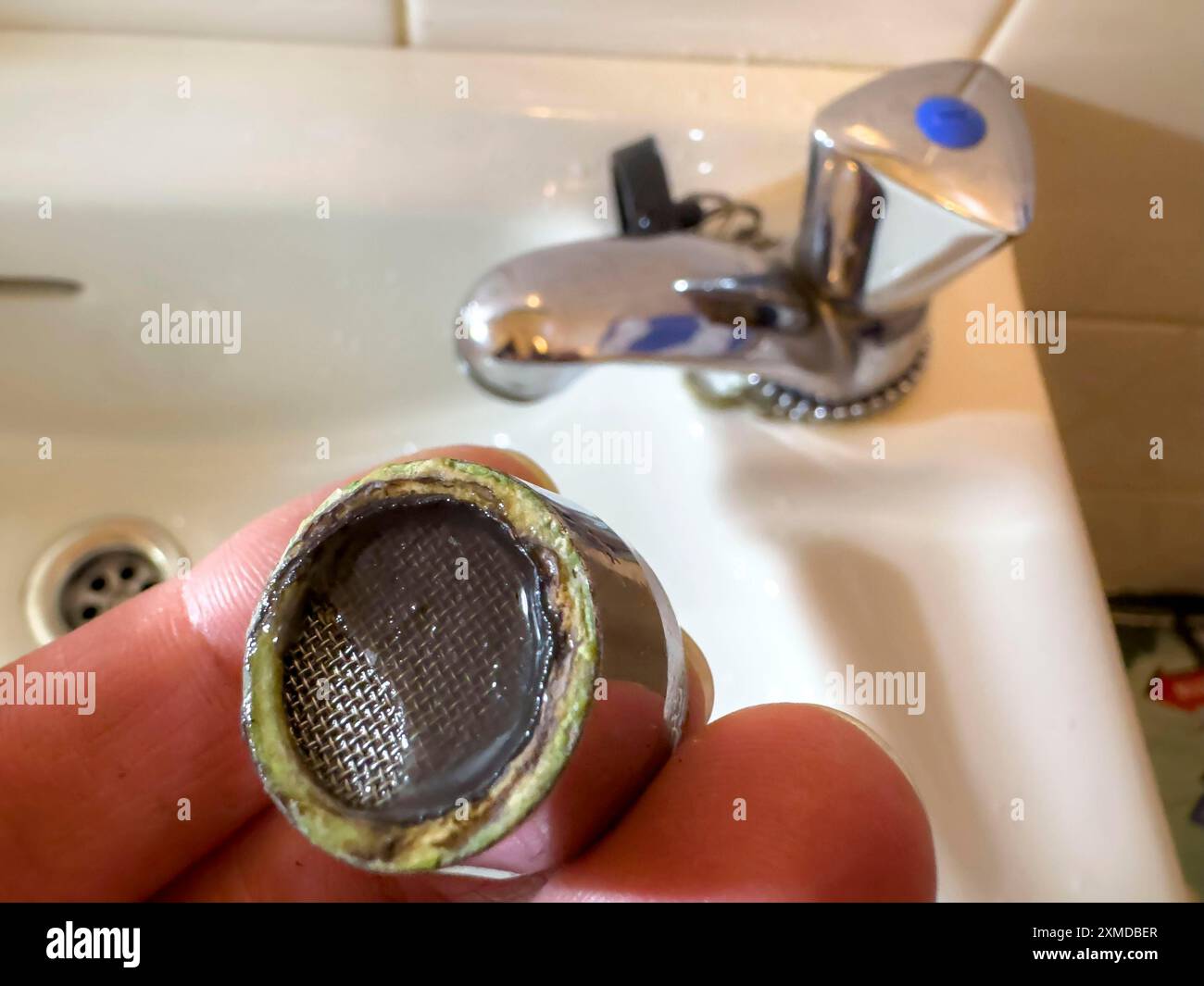 Calcified, clogged faucet aerator, limescale residue clogs the strainer ...