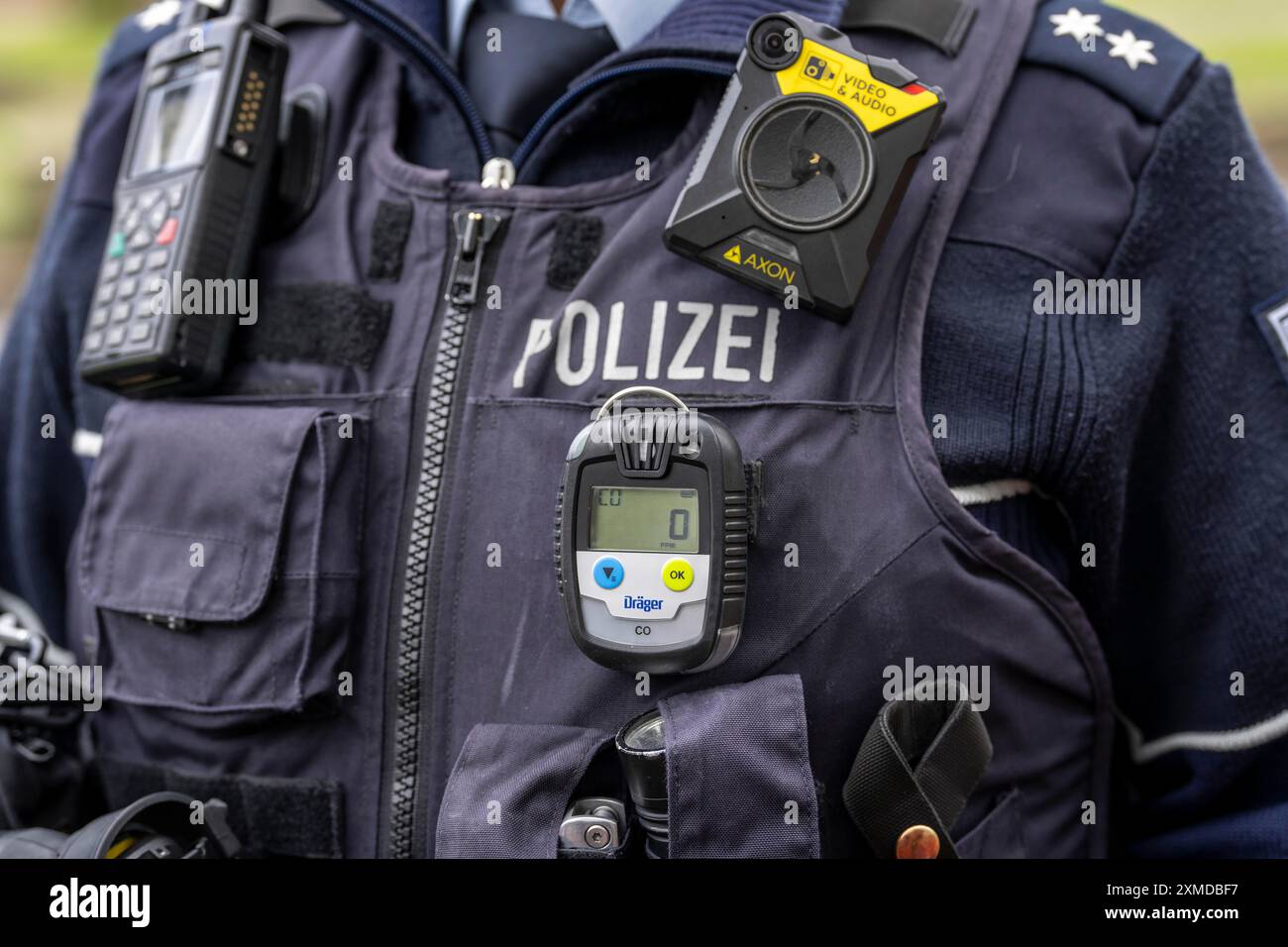 Police, policewoman with equipment waistcoat, CO measuring device ...
