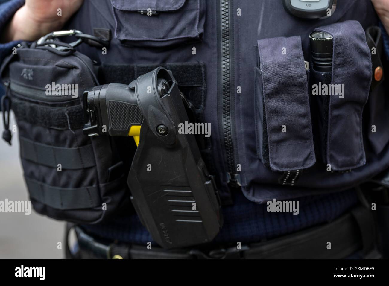 Police, policewoman with equipment waistcoat, first aid pack, taser ...