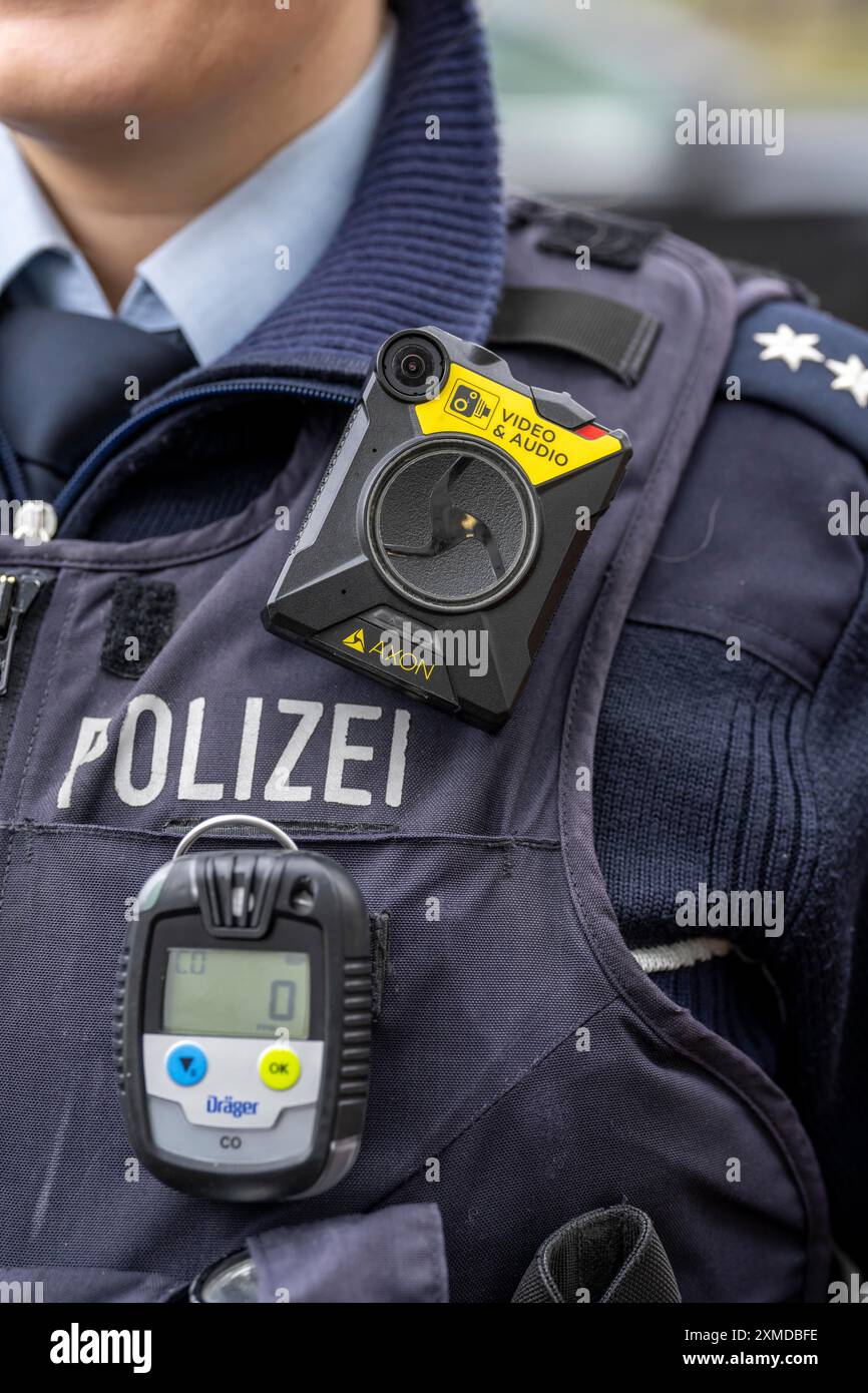 Police, policewoman with equipment waistcoat, CO measuring device ...