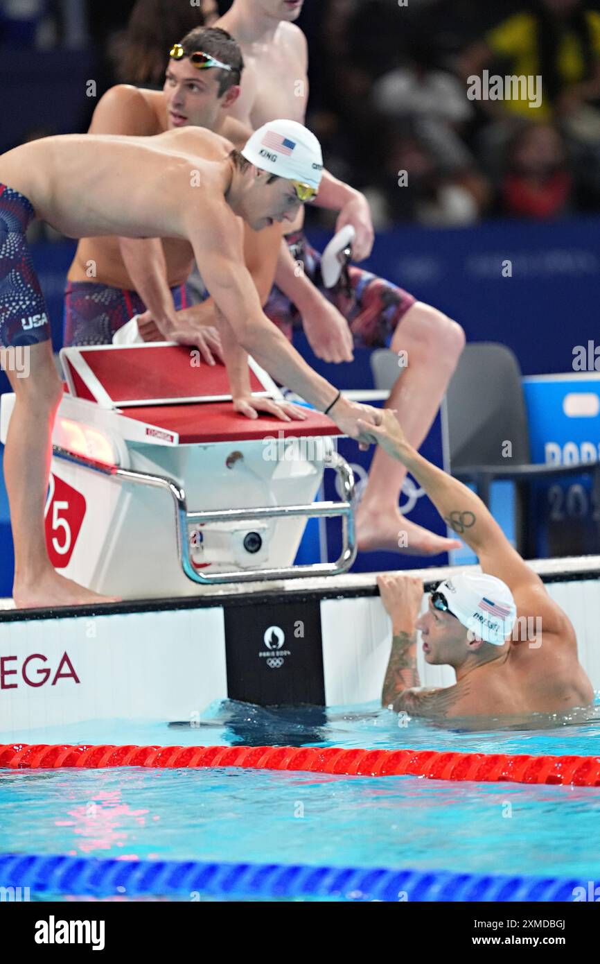 Paris, France. 27th July, 2024. Caeleb Dressel of Team USA, right, is ...