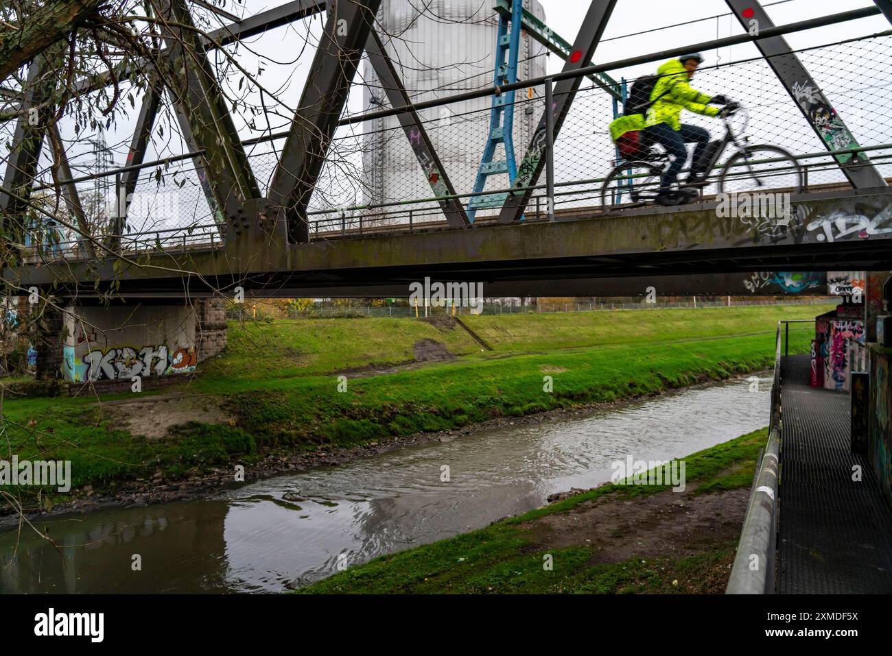 The River Emscher, sewage river, old railway bridge, now a footpath and ...