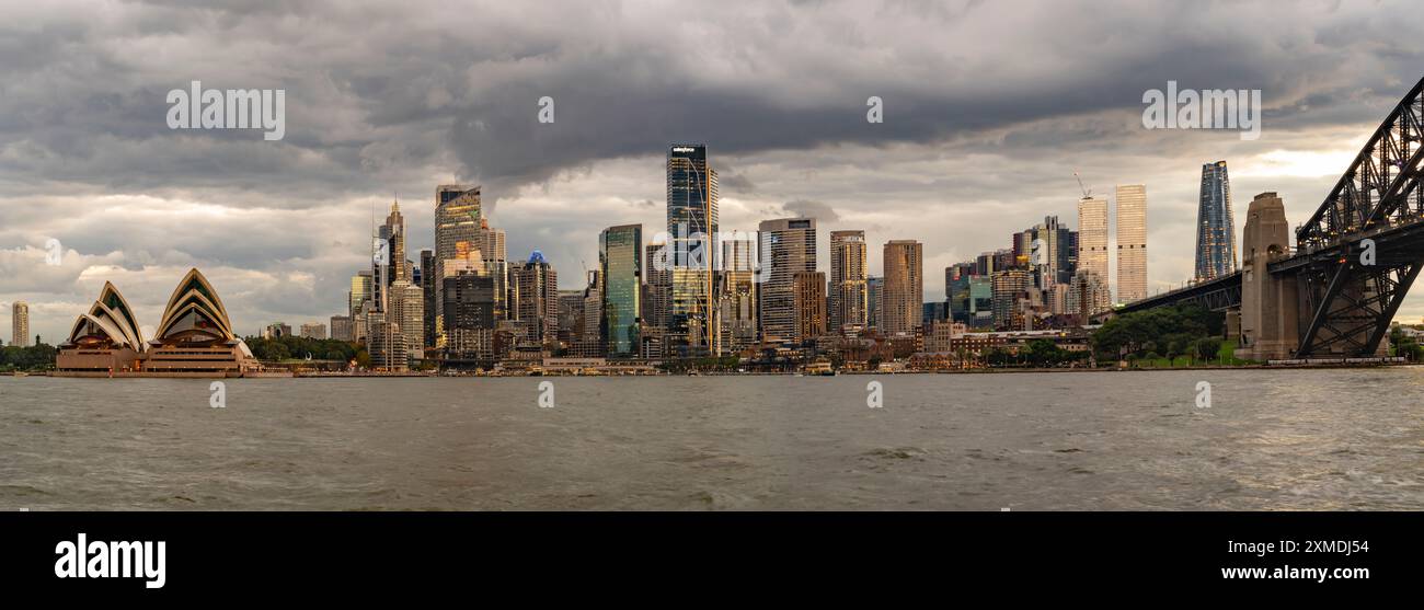 The Opera House and office towers illuminated at night in Sydney ...