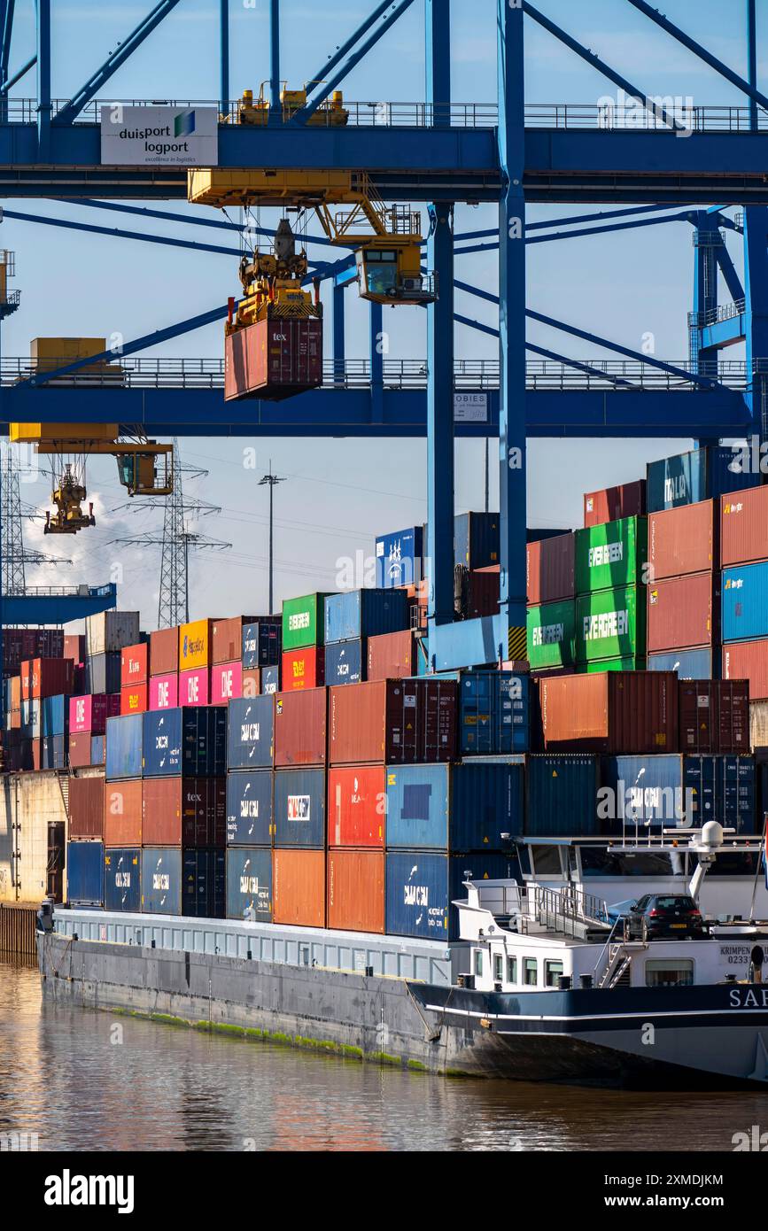 Container cargo ship in the harbour basin of the Logport, gantry cranes ...