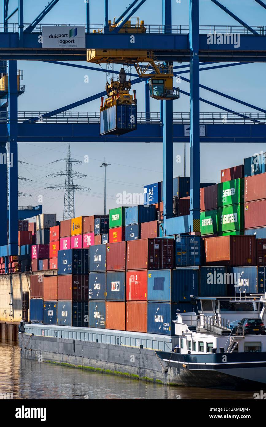 Container cargo ship in the harbour basin of the Logport, gantry cranes ...