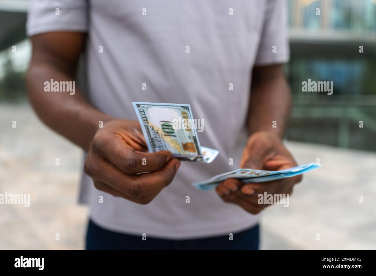 Man hands holding money dollar bills on urban street outdoor ...