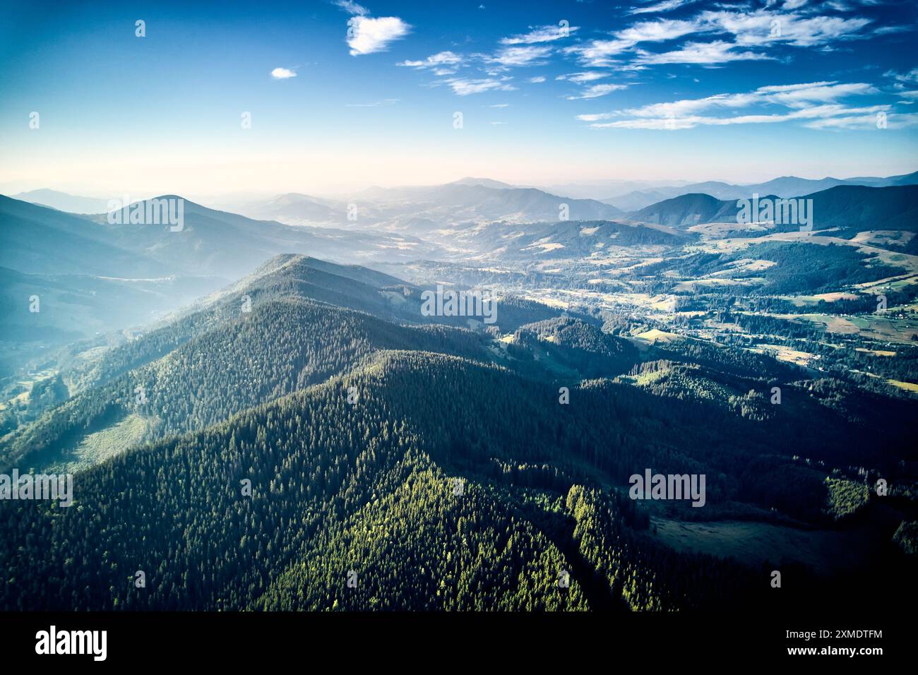 Aerial view of densely forested mountains stretching into distance ...