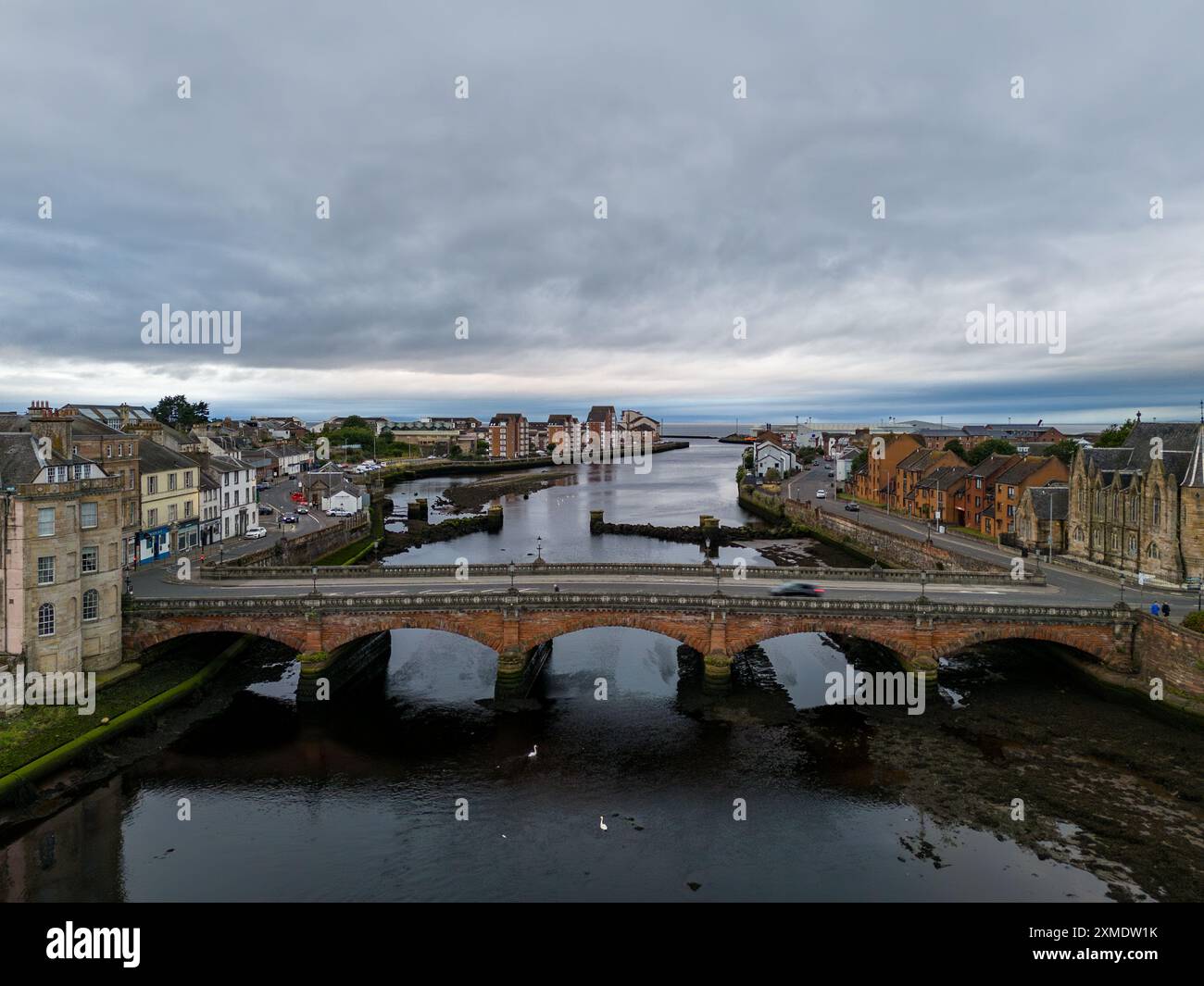 Old stone bridge is connecting two sides of a scottish town under a ...