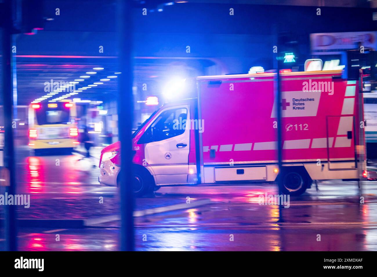 Ambulance on alarm, DRK, Essen fire brigade, rainy weather, city centre ...