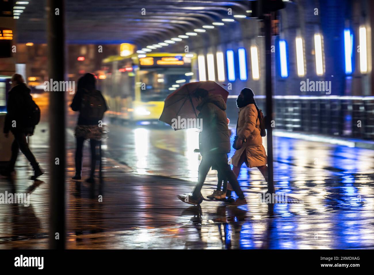 Illuminated subway at the main railway station, pedestrians at a ...