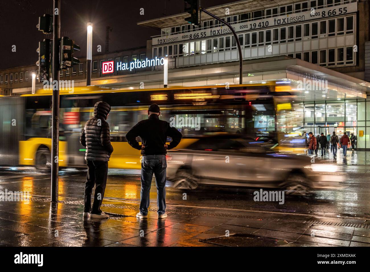 Passers-by at a pedestrian crossing, at the main railway station, rainy ...