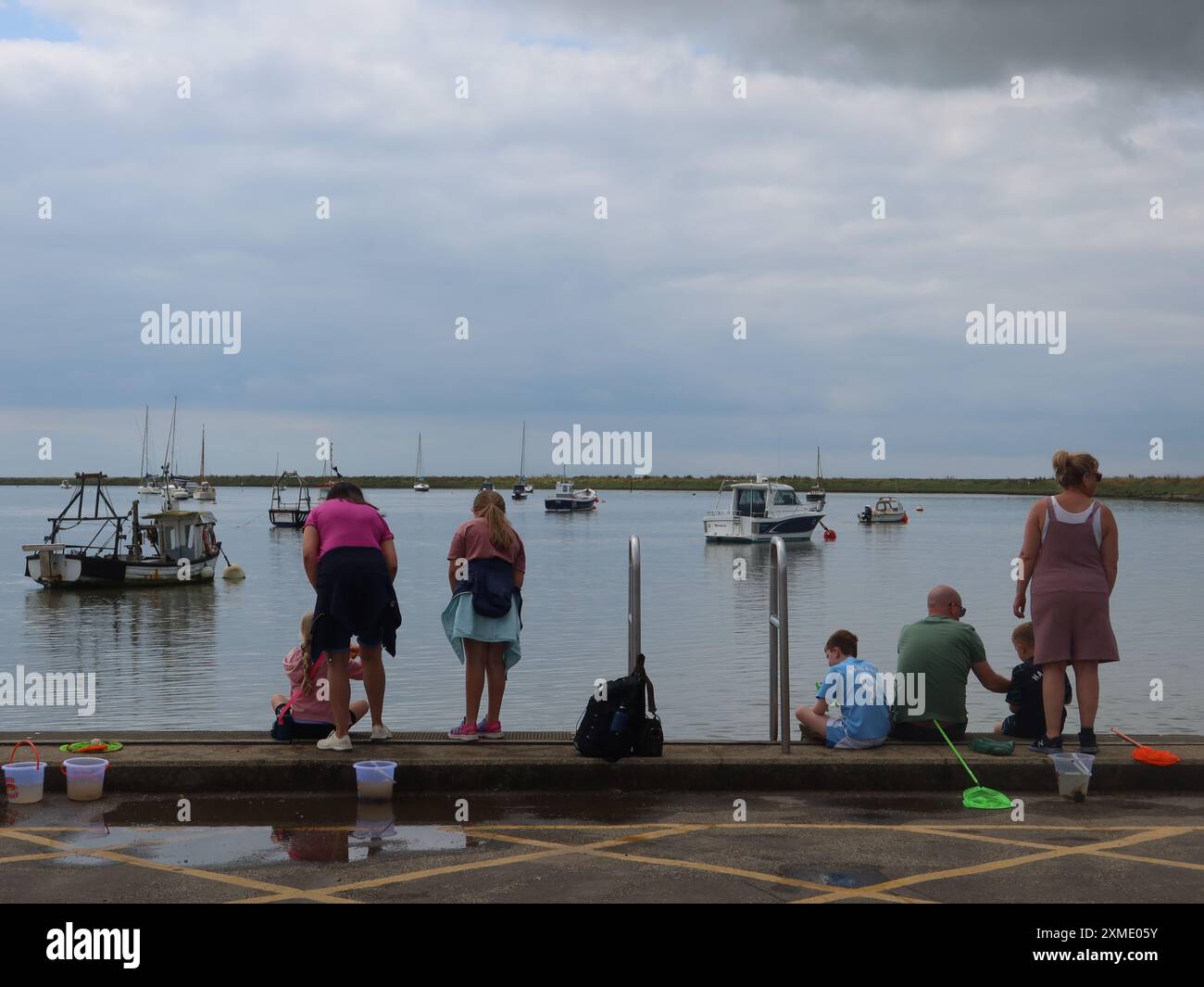 Summer holidays in Suffolk: families with children lined along the ...