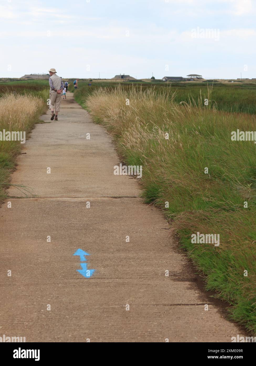 A man walks along a footpath at Orford Ness, the largest shingle spit ...