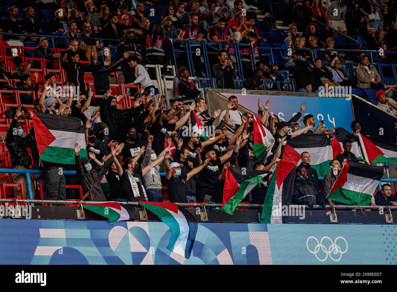 Spectators wave Palestinian flags during the men's group D match ...