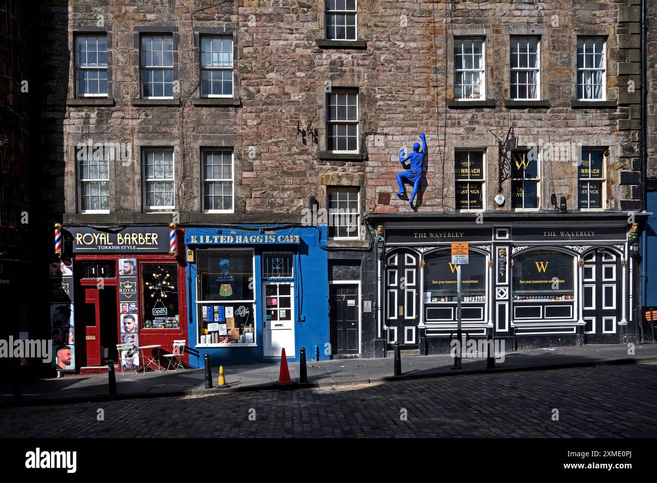 Sunlit shopfronts and tenements in St Mary's Street in Edinburgh's Old ...