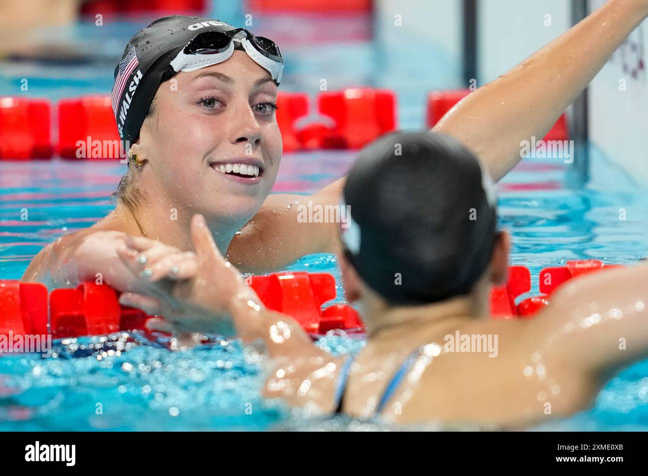 Gretchen Walsh, of the United States, background, celebrates after ...