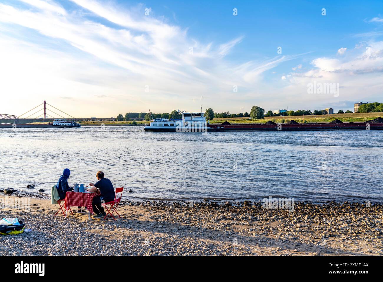 The Rhine at Duisburg-Baerl, man and woman having a picnic on the Rhine ...