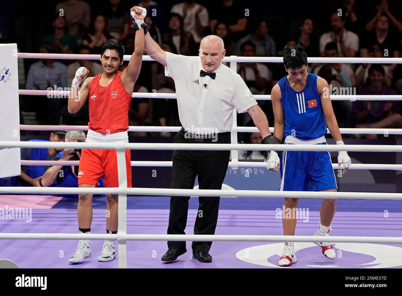 India's Preeti, left, reacts after defeating Vietnam's Vo Thi Kim Anh ...