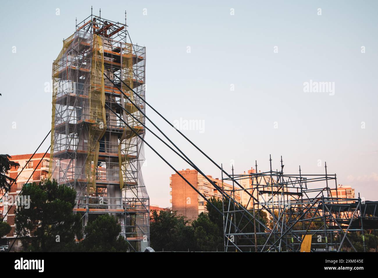 Unfinished architectural object in progress with protective net on ...