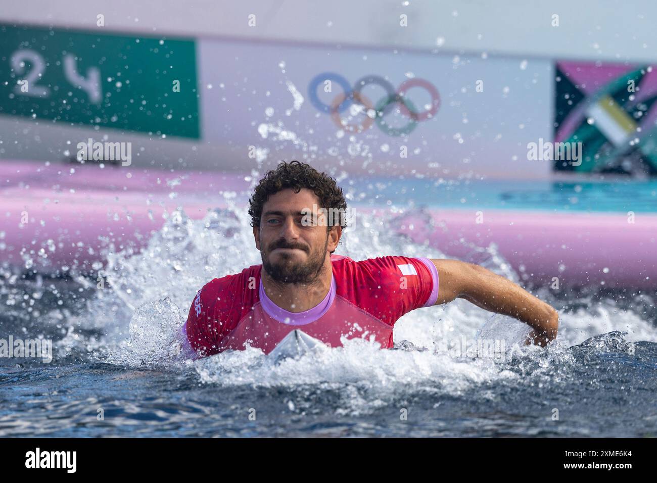 Peru's Alonso Correa enters the water, during round one of the surfing ...
