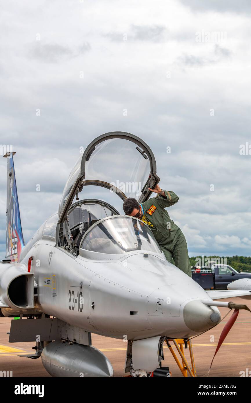 military jet fighter pilot looking into the cockpit of a fast fighter bomber jet plane at RIAT ...