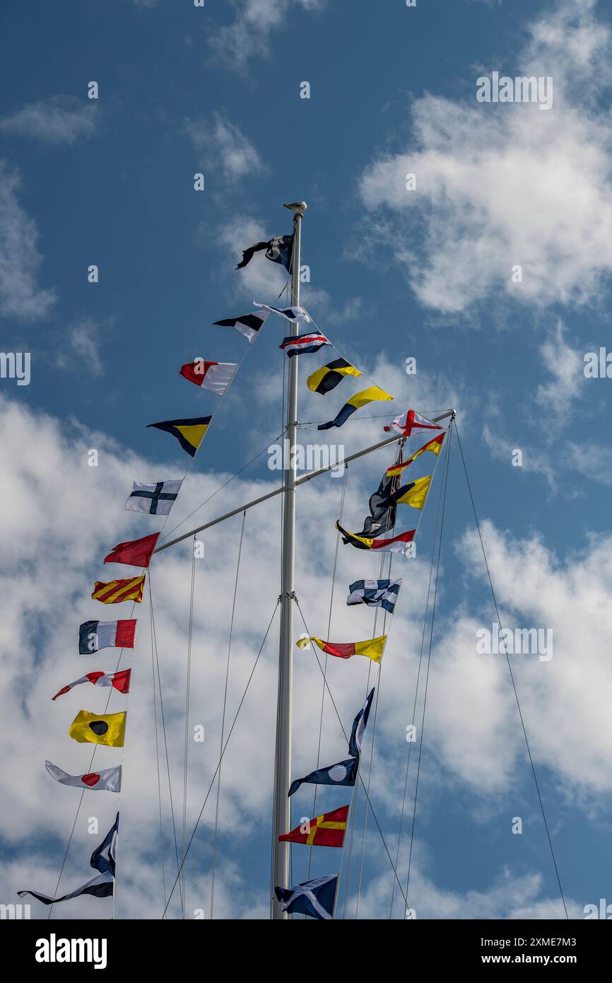 colourful maritime or nautical flags flying from a mast at the royal ...