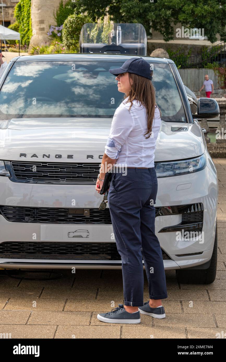 Young woman on Land Rover advertising stand at Cowes Week yachting ...