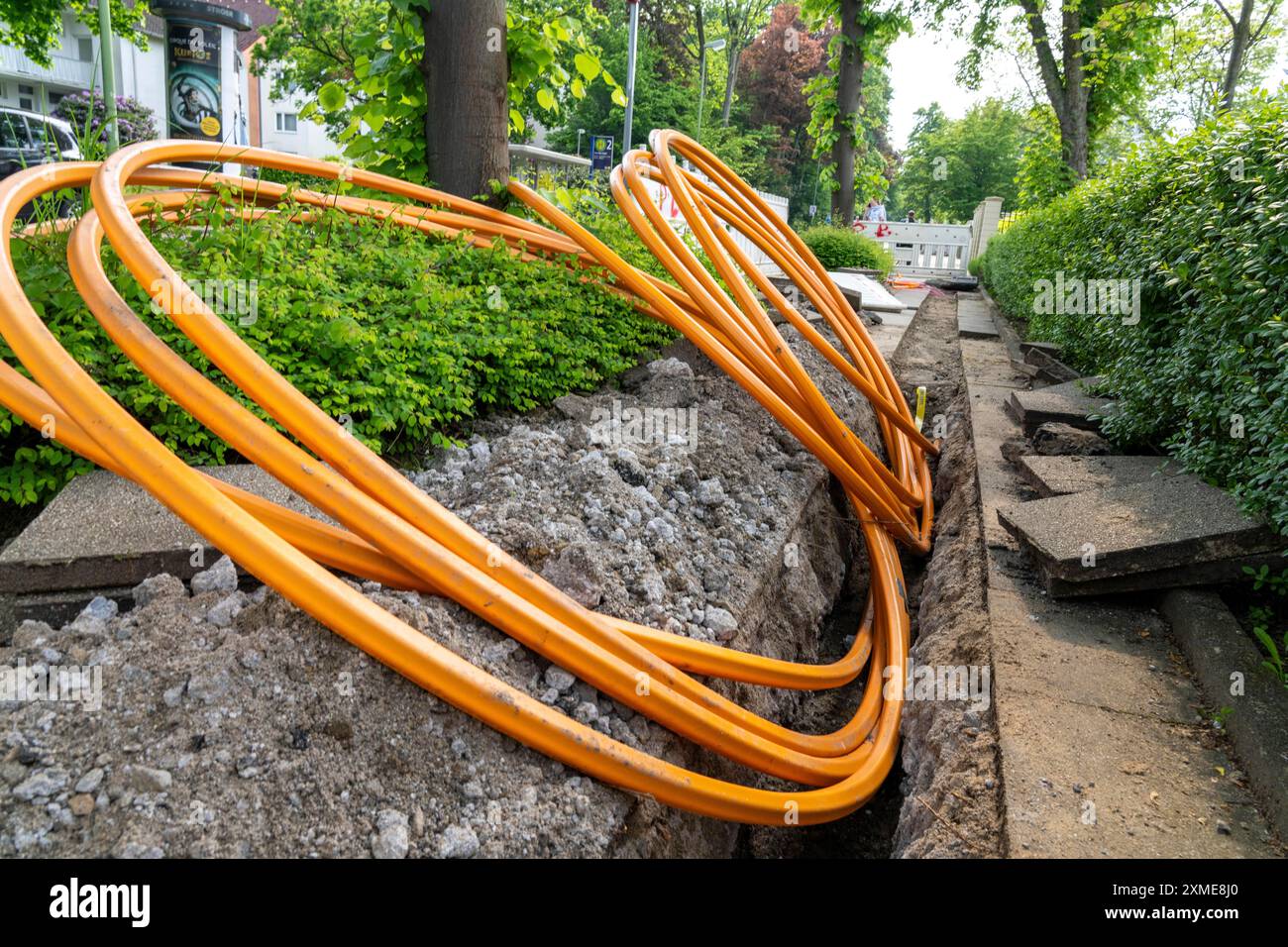 Laying of fibre optic cables, empty conduits are laid under a pavement ...