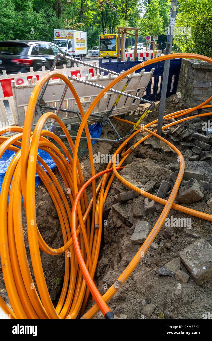 Laying of fibre optic cables, empty conduits are laid under a pavement ...