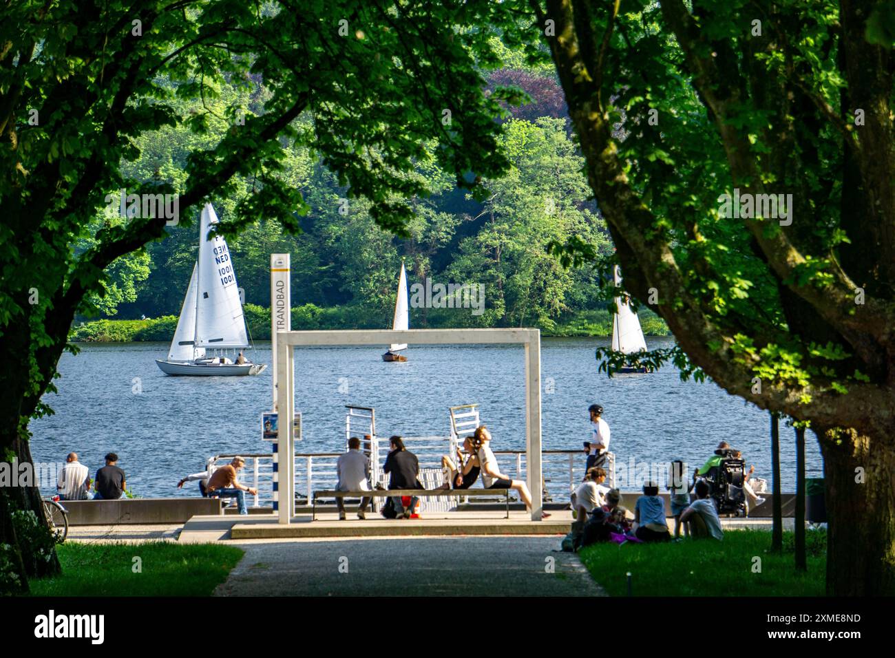 Lake Baldeney in Essen, tree-lined avenue at Seaside Beach, jetty of ...