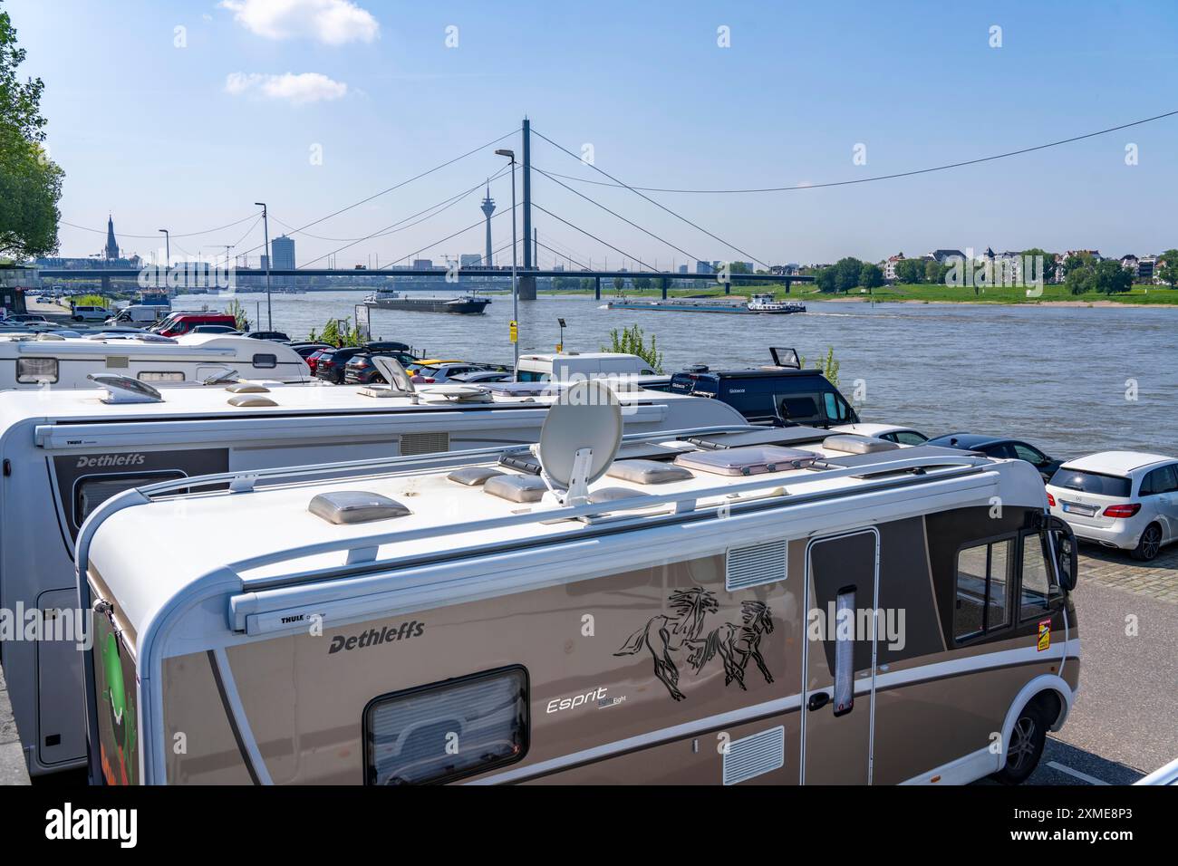 Motorhome parking space on the banks of the Rhine, Duesseldorf skyline ...