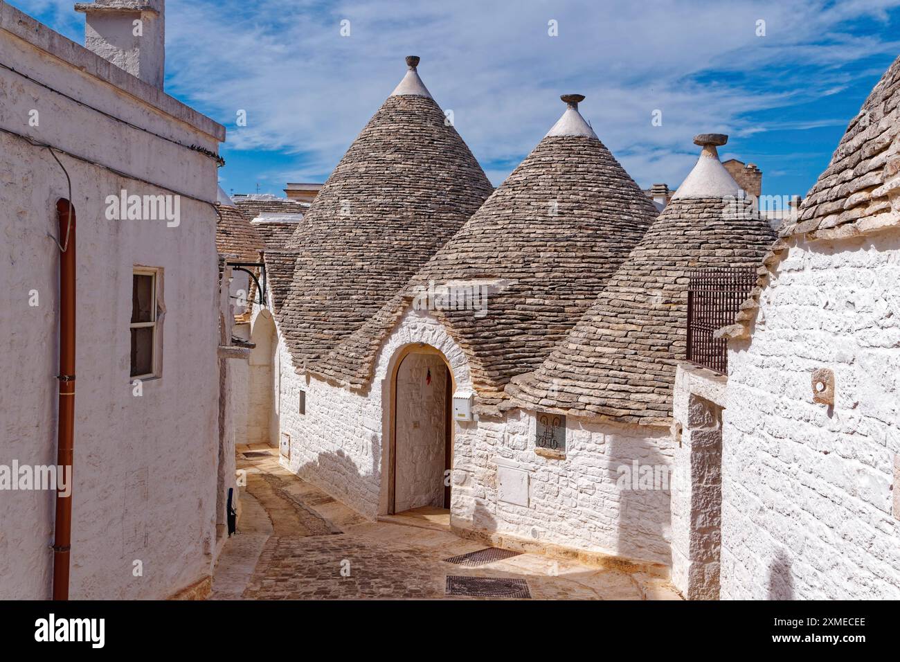 Whitewashed trulli, round houses with stone roofs, in the southern ...